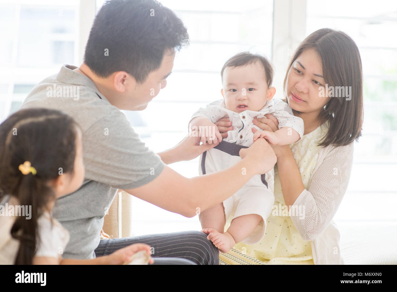 Happy Asian family at home, parents and children, natural living ...