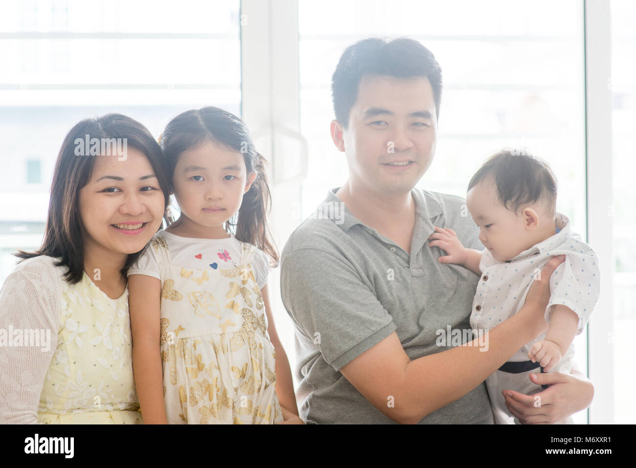 Parents and children. Happy Asian family spending quality time at home ...