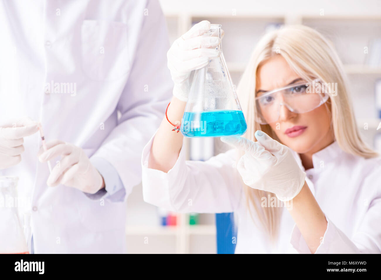 Young woman chemist working in clinic lab Stock Photo - Alamy