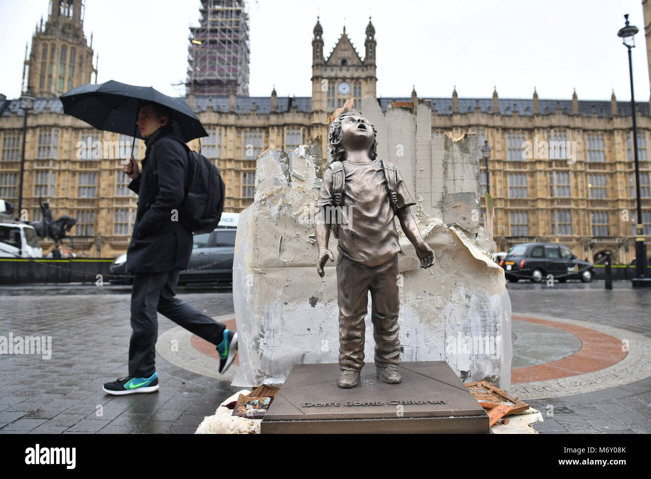 A life-size statue of a child placed by Save the Children next to the ...