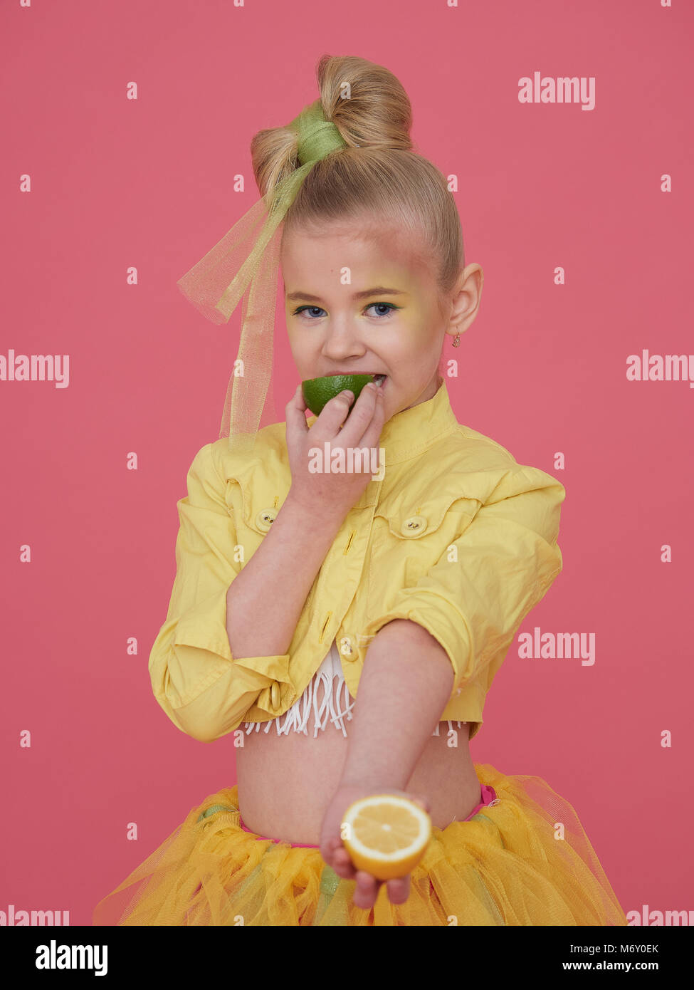 A small child changed into a suit of bright yellow lemon. On the girl's ...