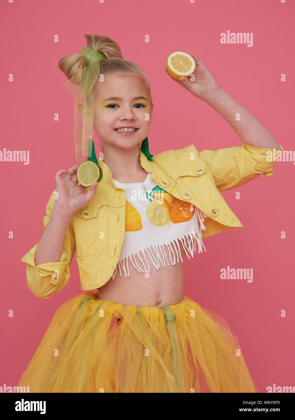 A small child changed into a suit of bright yellow lemon. On the girl's ...