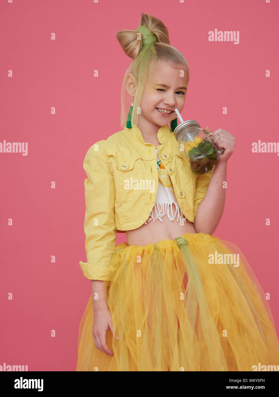 A small child changed into a suit of bright yellow lemon. On the girl's ...