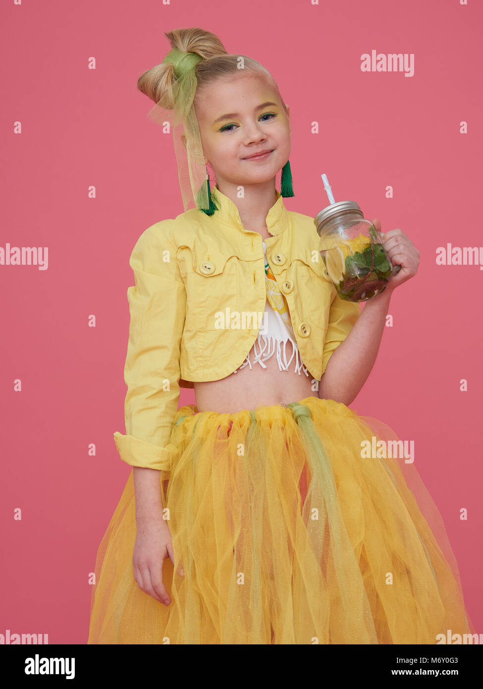 A small child changed into a suit of bright yellow lemon. On the girl's ...