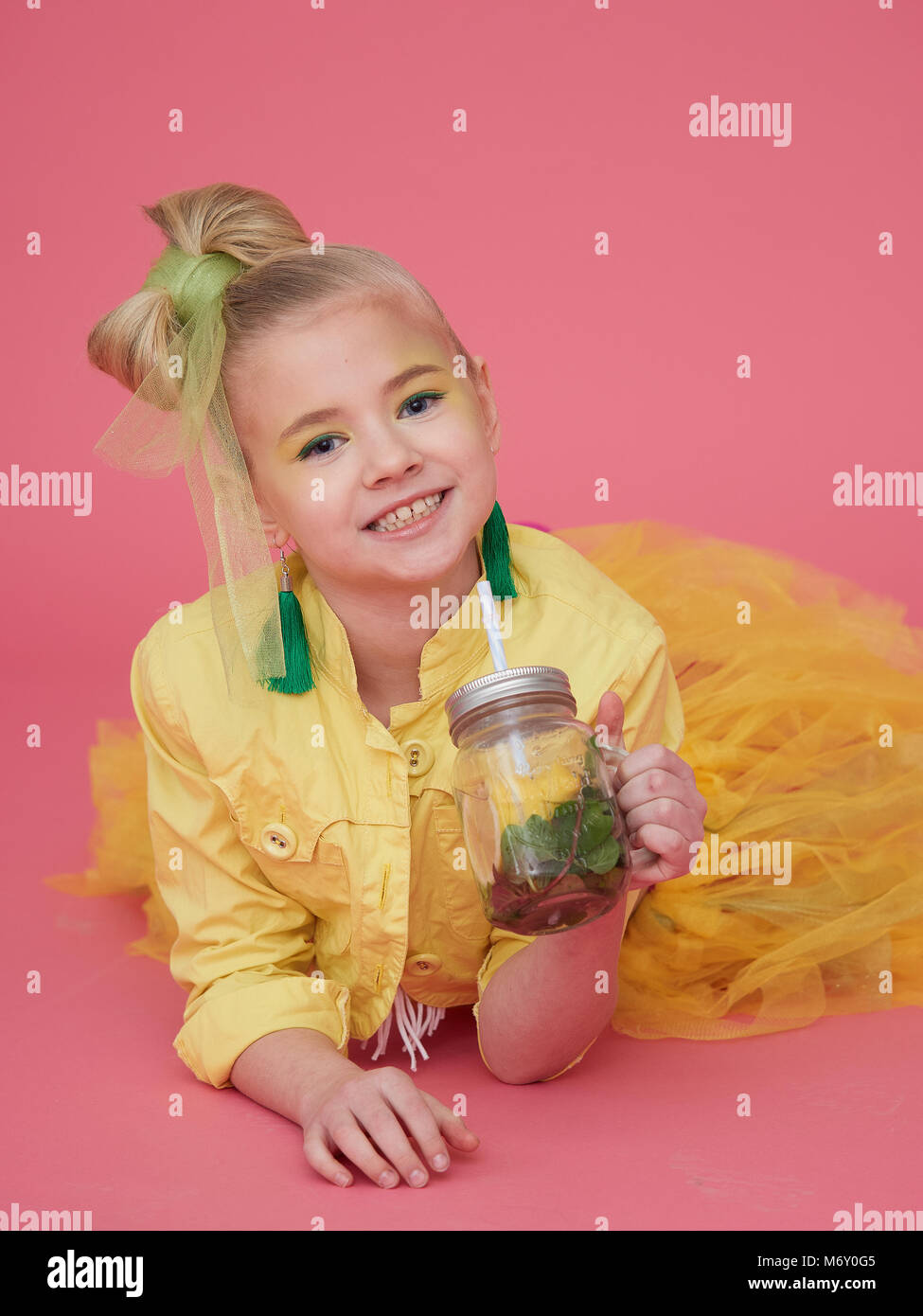A small child changed into a suit of bright yellow lemon. On the girl's ...