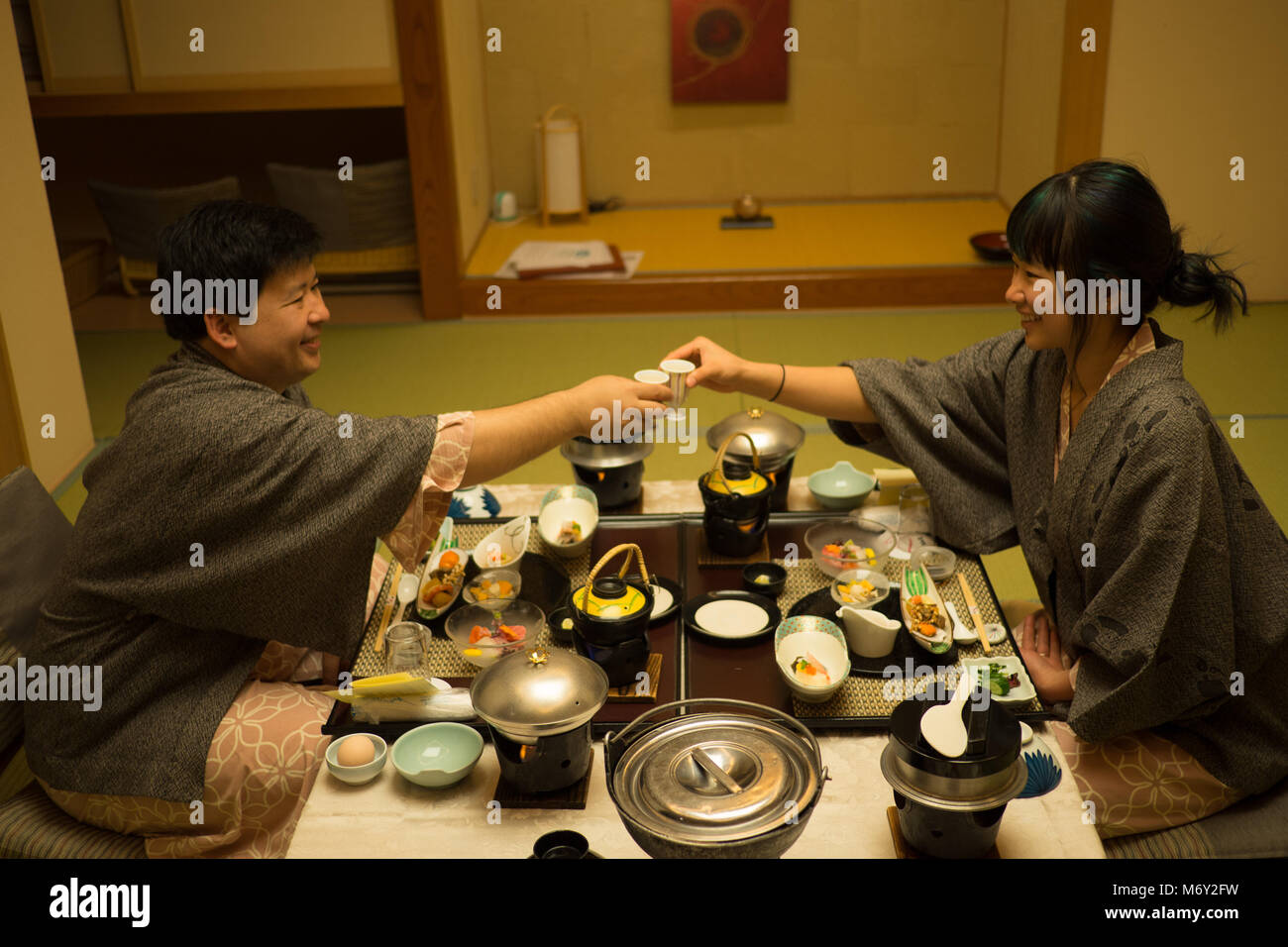 Two people enjoying a traditional Japanese dinner together also known ...