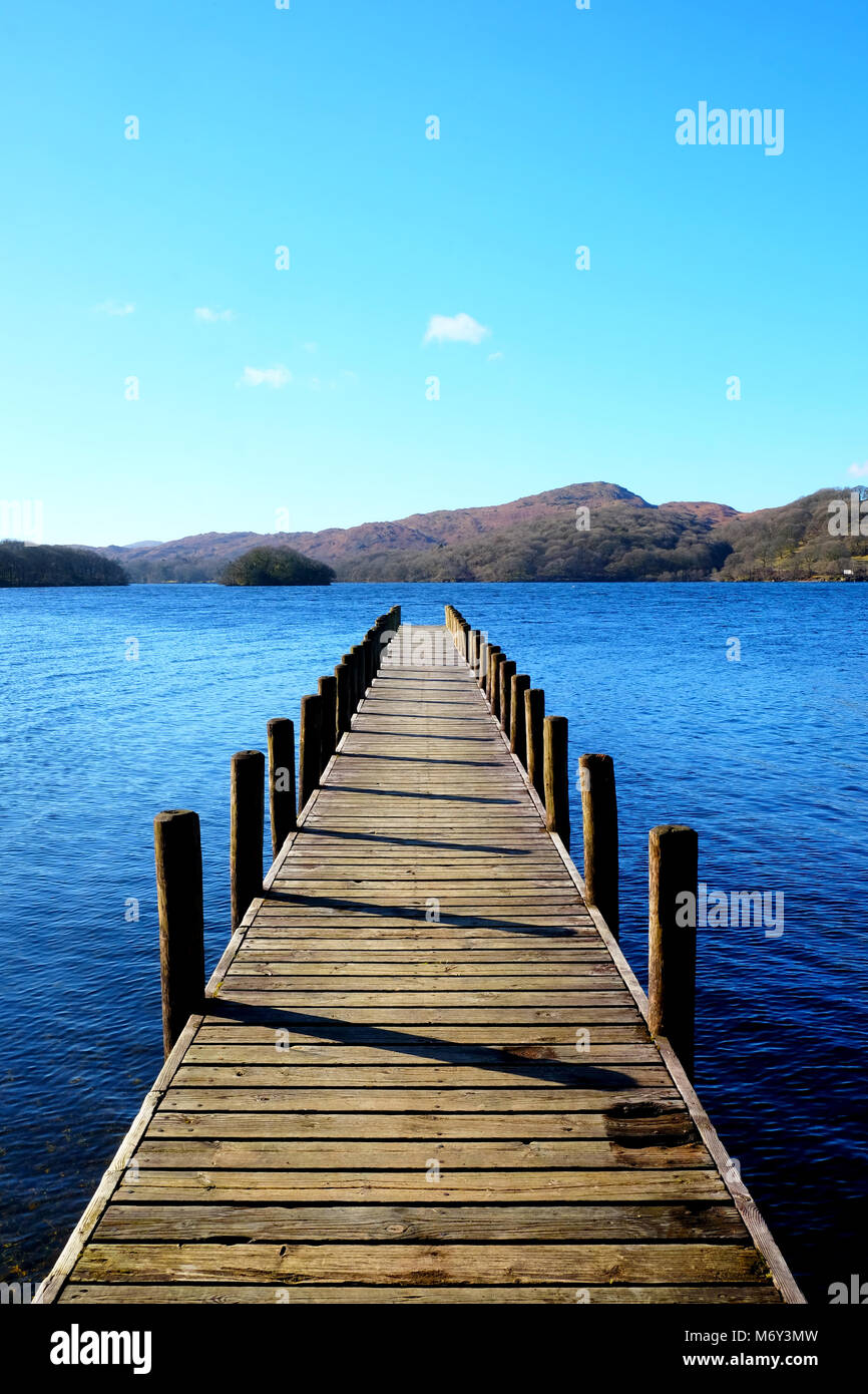 Long straight symetrical beautiful wooden foot jetty jutting out over a ...