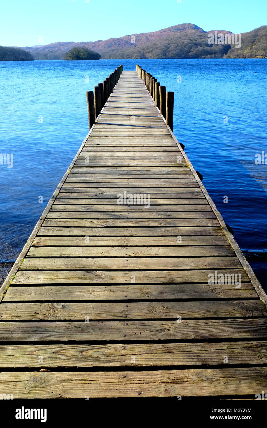 Very Long straight symetrical wooden foot jetty jutting out over a calm ...