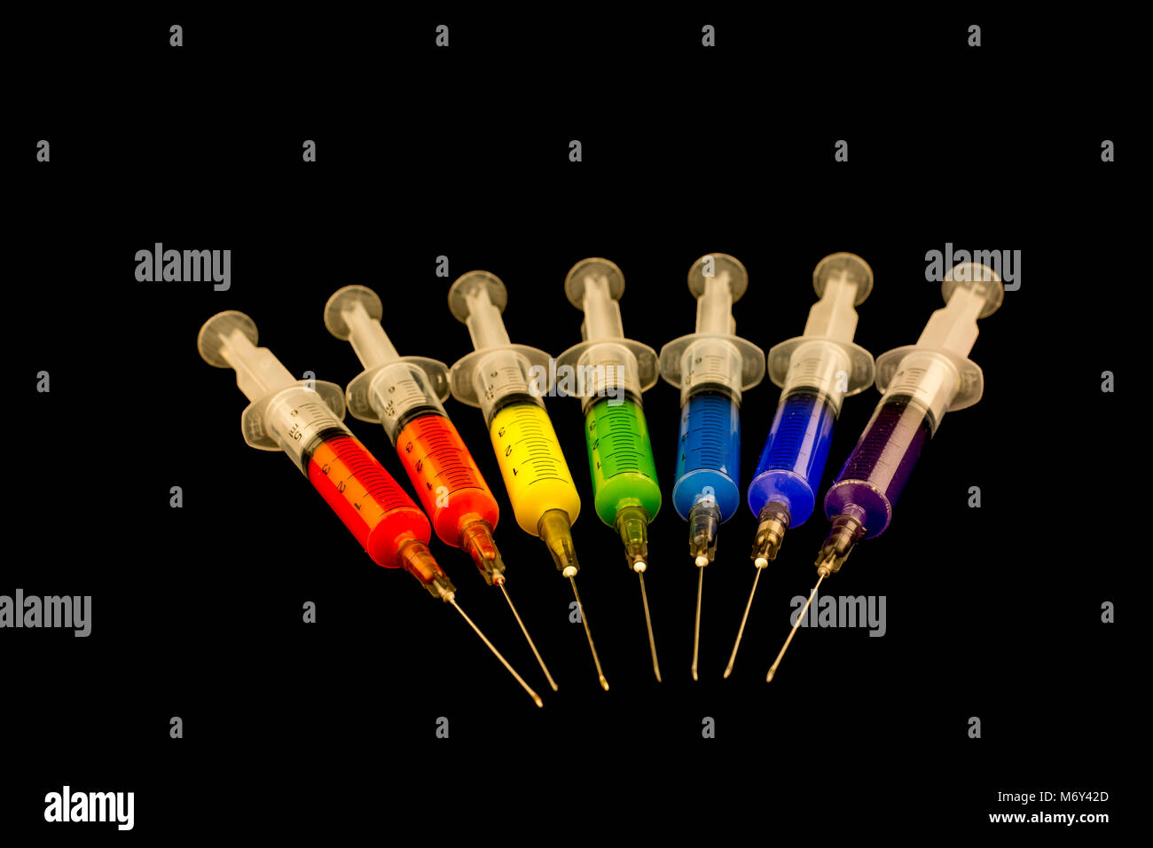 Syringes with colored serum isolated on black background Stock Photo ...