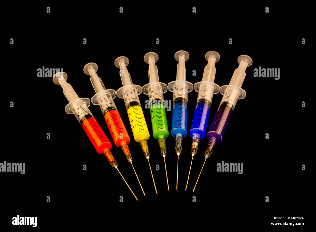 Syringes with colored serum isolated on black background Stock Photo ...