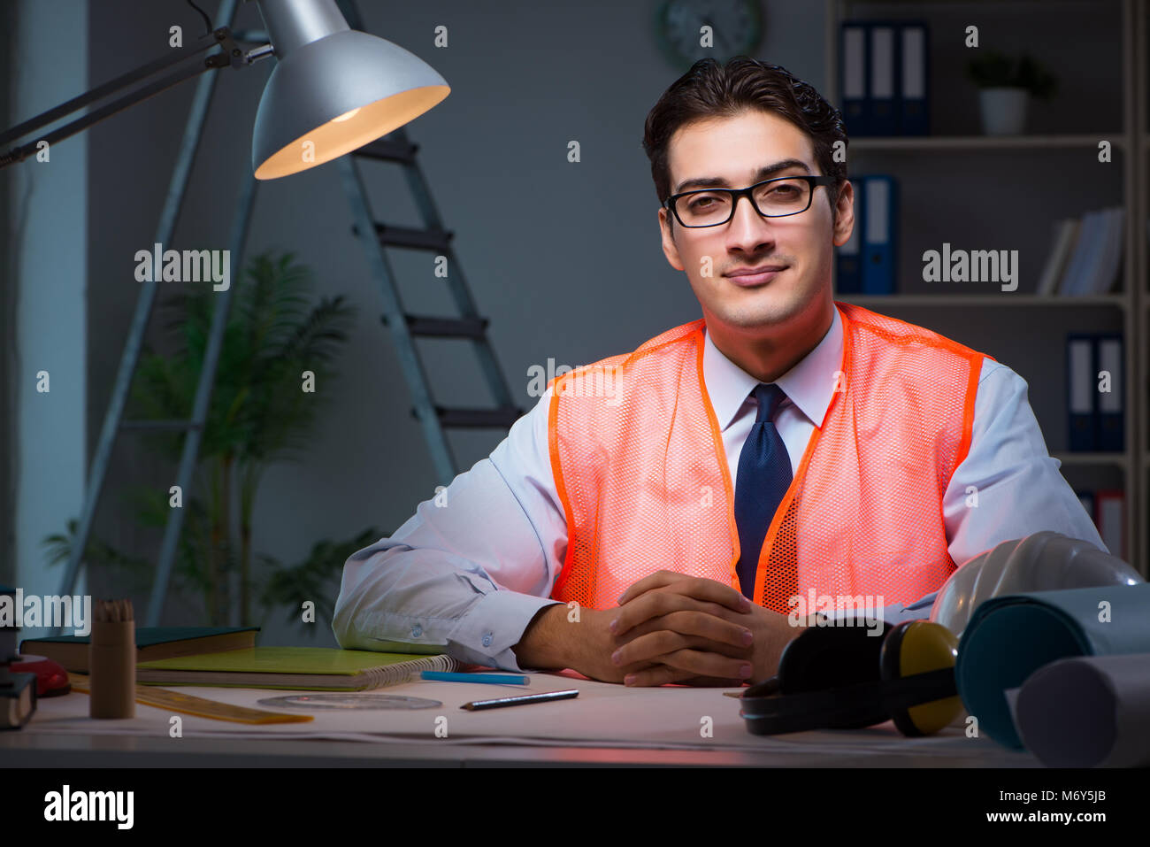 Construction architect working on drawings late at night Stock Photo ...
