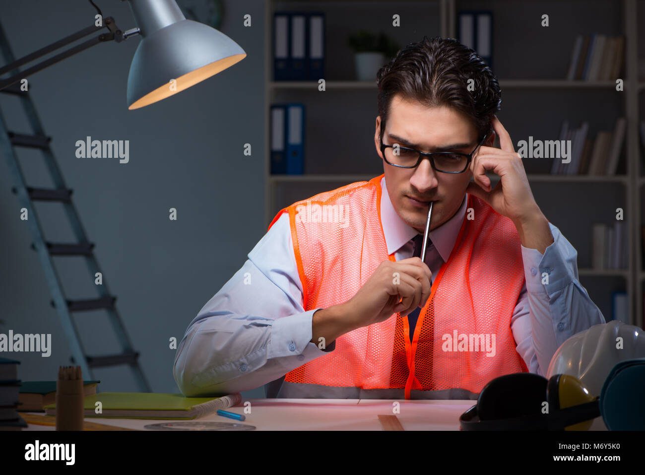 Construction architect working on drawings late at night Stock Photo ...
