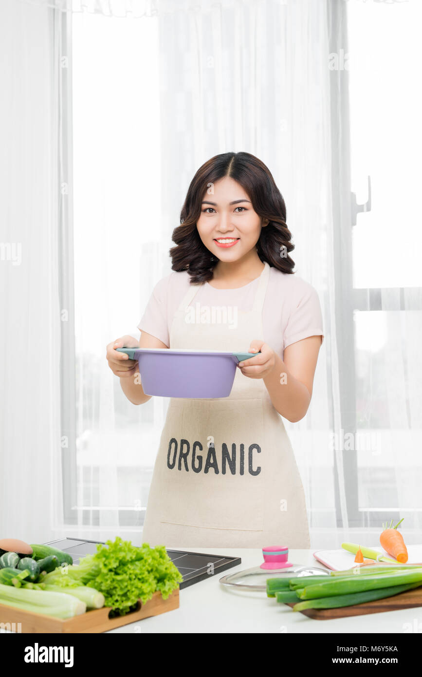 Healthy food. Young asian woman cooking in the kitchen at home Stock ...