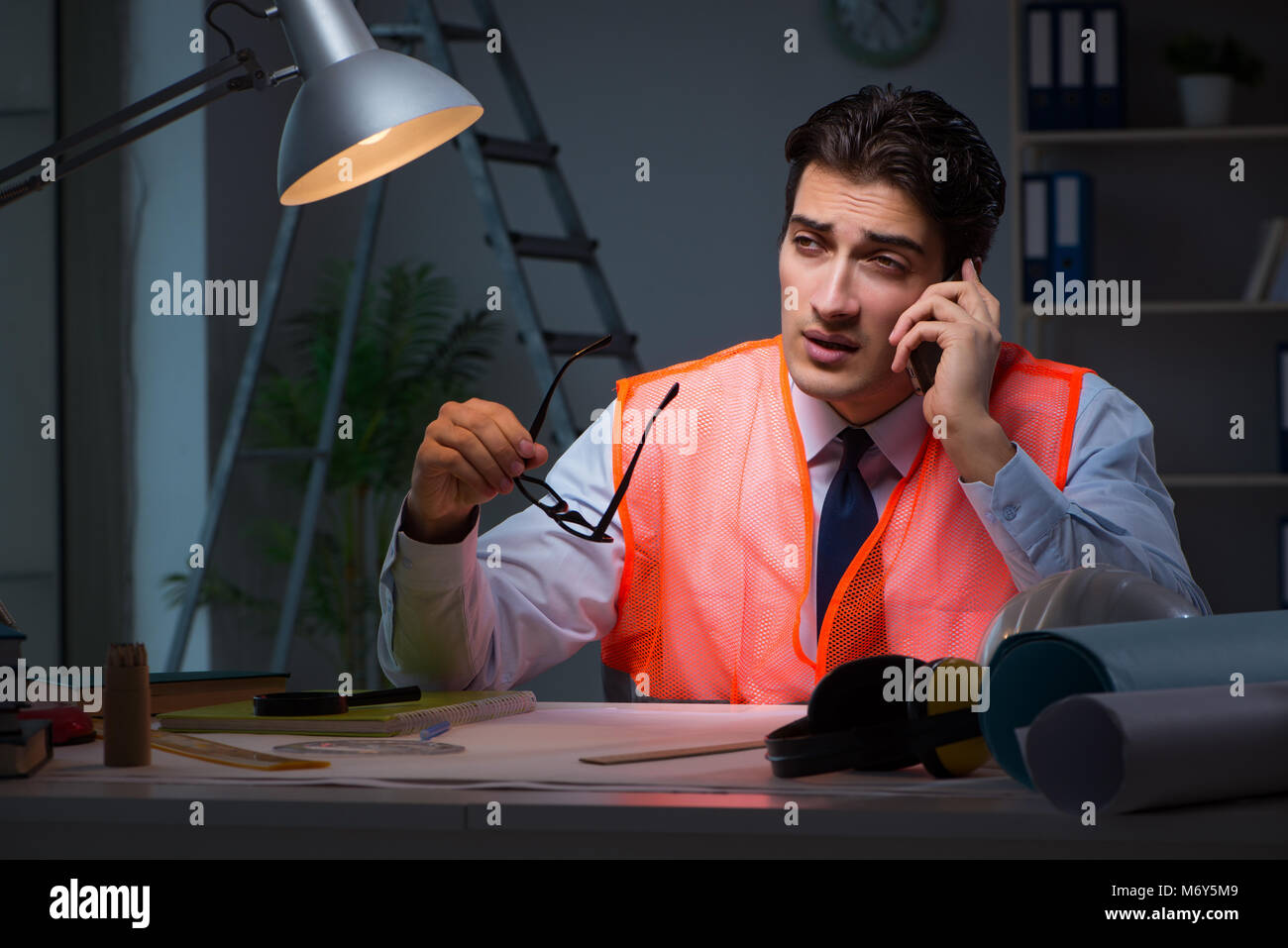 Construction architect working on drawings late at night Stock Photo ...