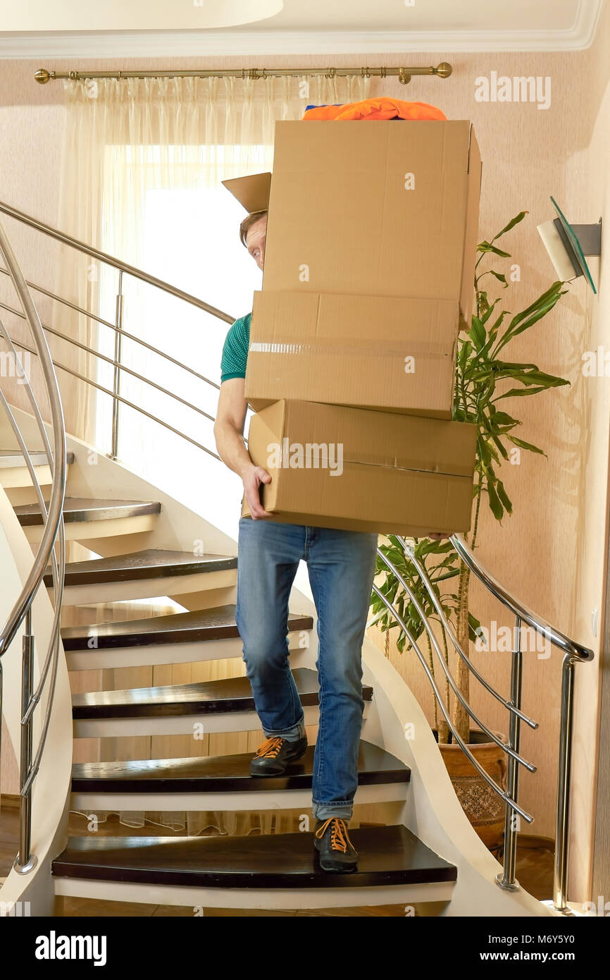 Guy carrying stack of boxes Stock Photo - Alamy