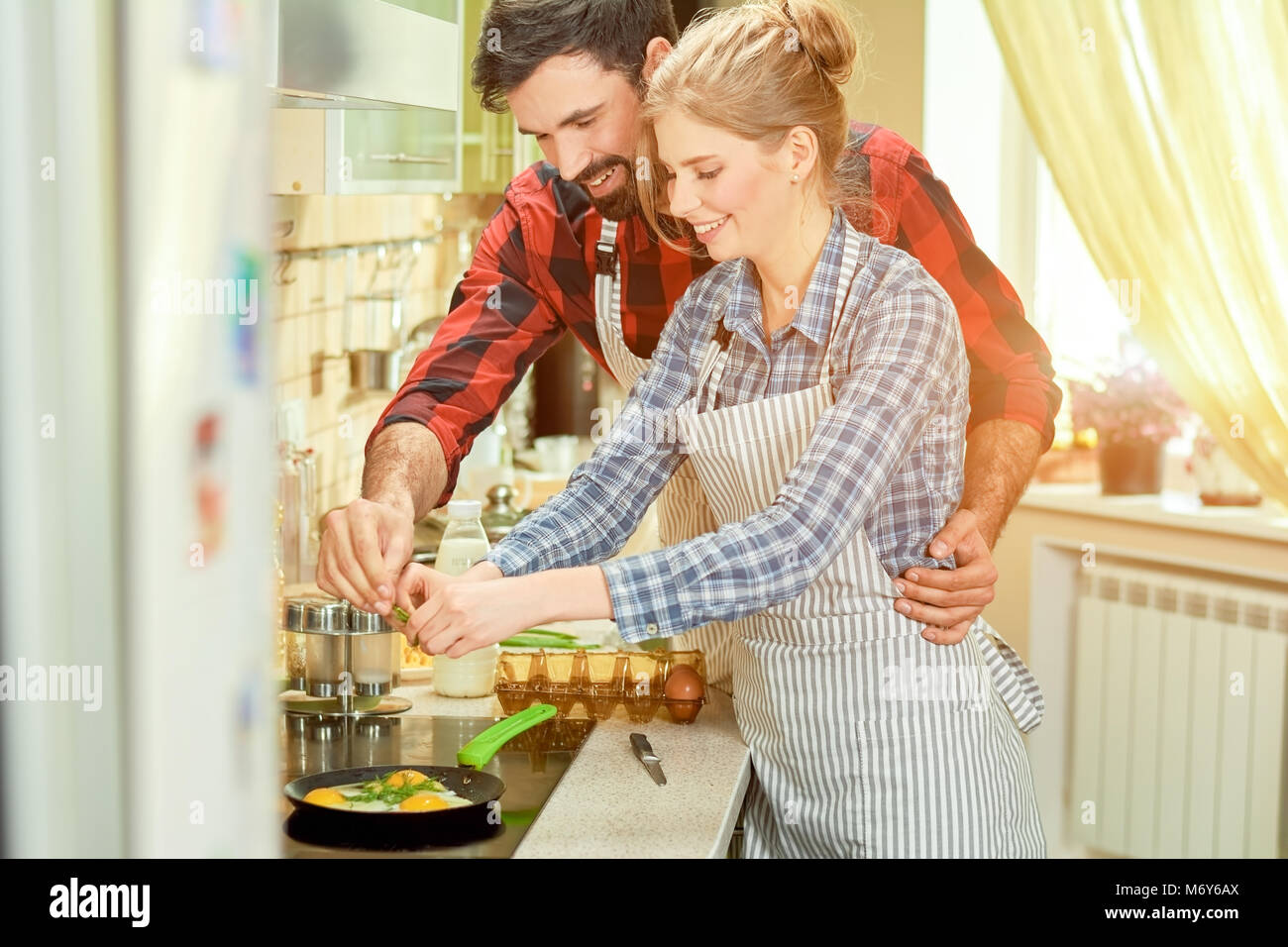 Cheerful man and woman cooking Stock Photo - Alamy