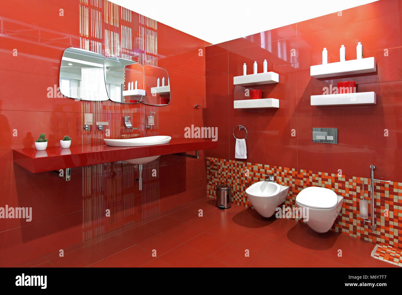 Modern bathroom with red ceramic walls and contemporary fixtures Stock ...