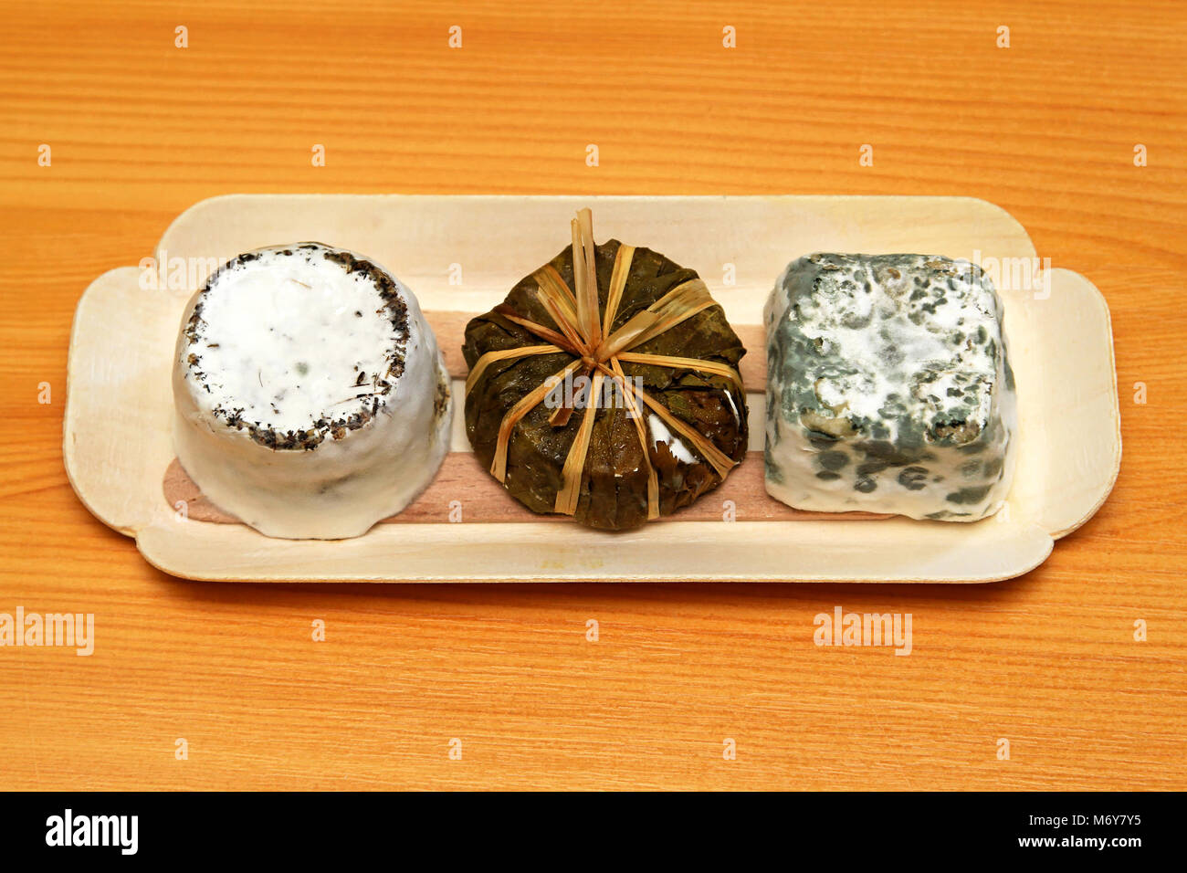 Assortment of blue cheese on wooden plate Stock Photo - Alamy