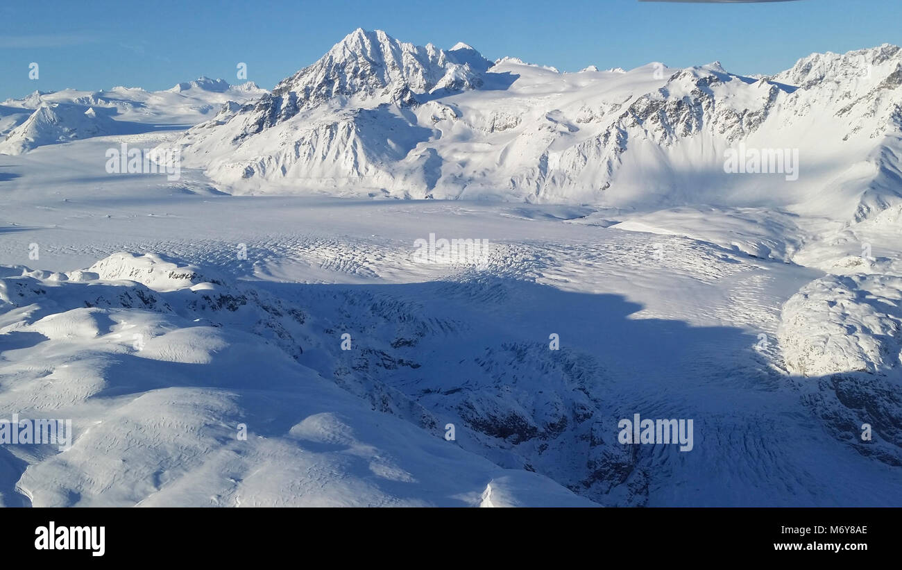 Double Glacier . A snow covered glacier between two snowy mountain ...