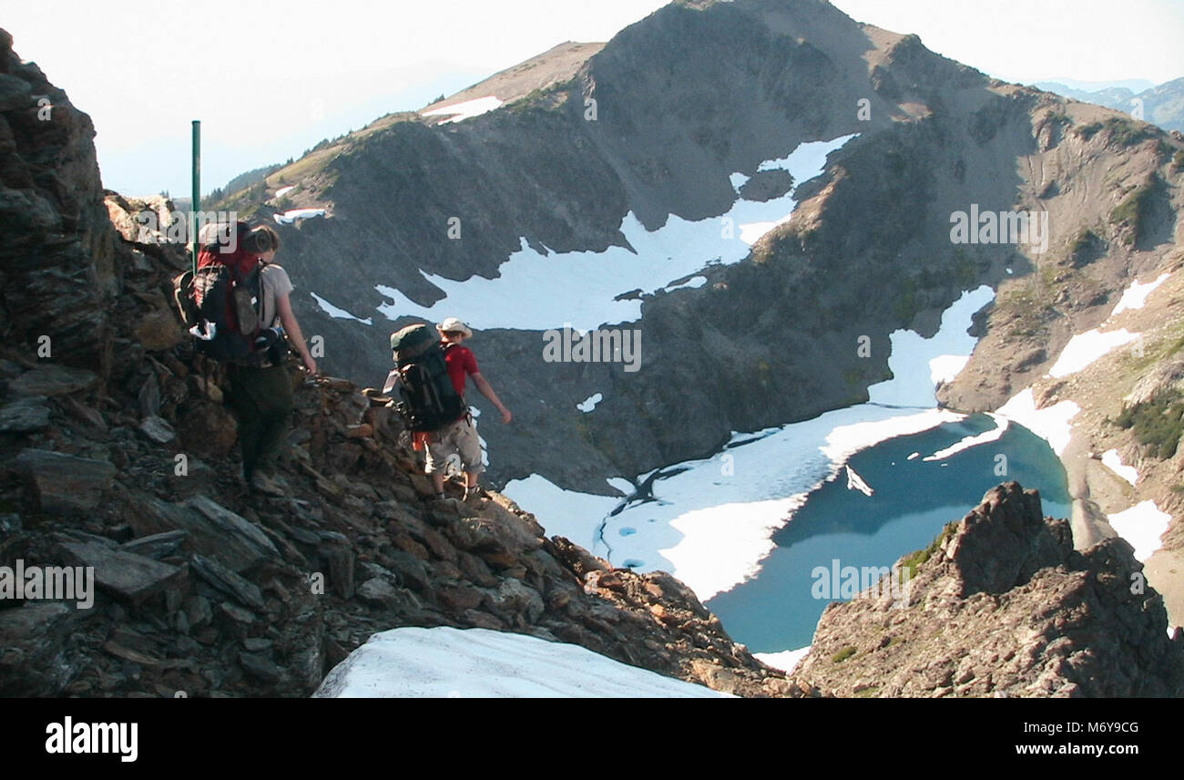 hiking alpine backpacking steep lake ice WIC Stock Photo - Alamy