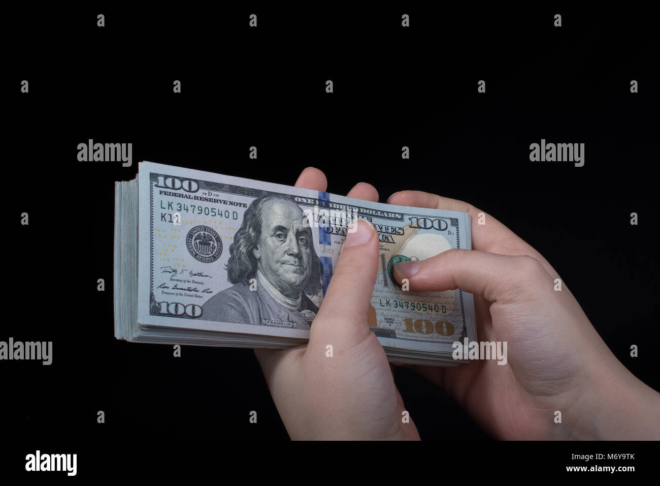 Hand holding American dollar banknotes isolated on white background ...