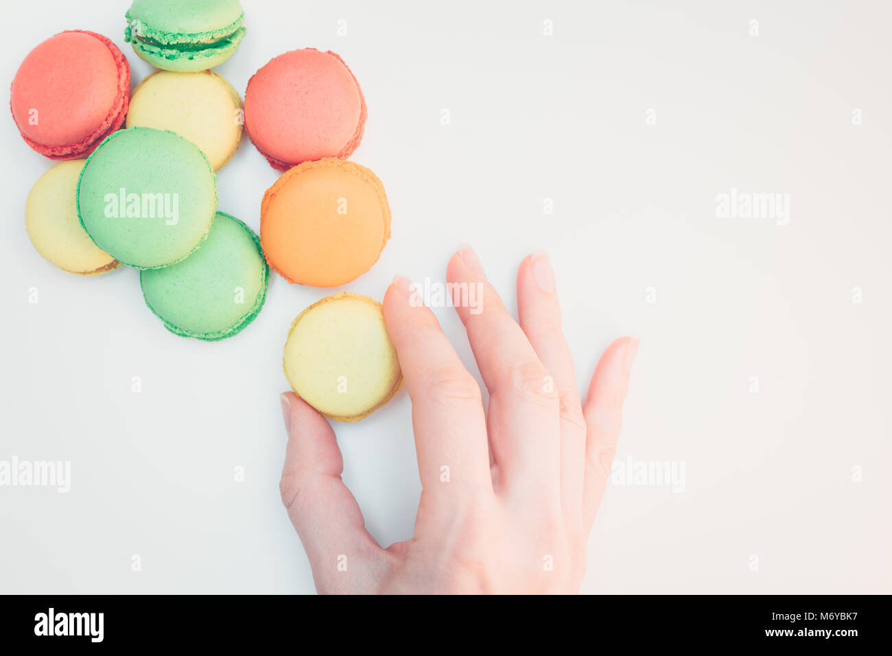 Assorted sweet pastel color macaroons on white background top view ...