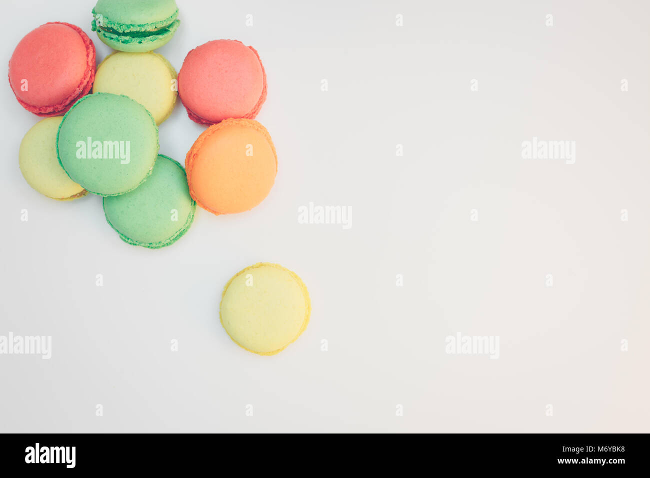 Assorted sweet pastel color macaroons on white background top view ...