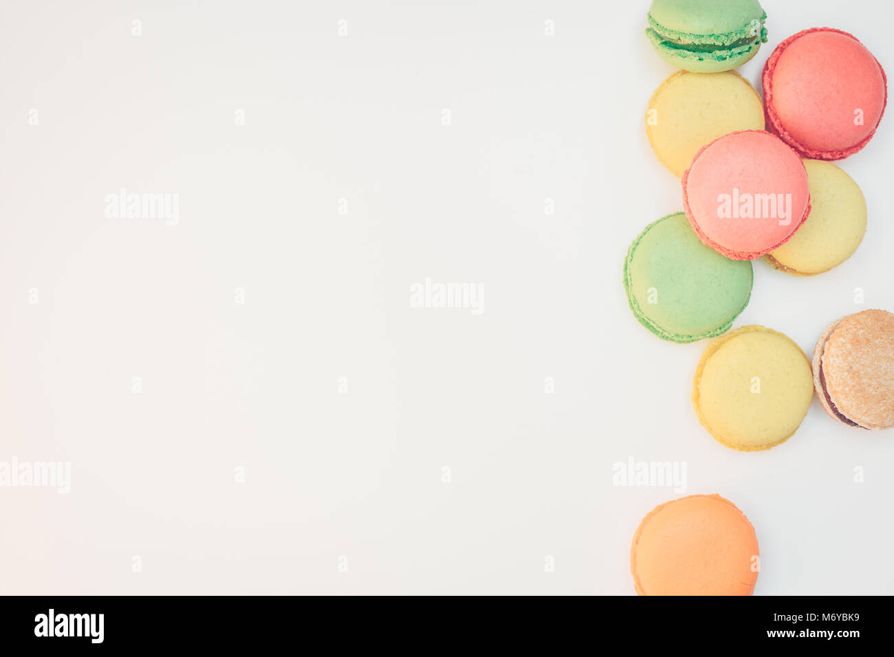 Assorted sweet pastel color macaroons on white background top view ...