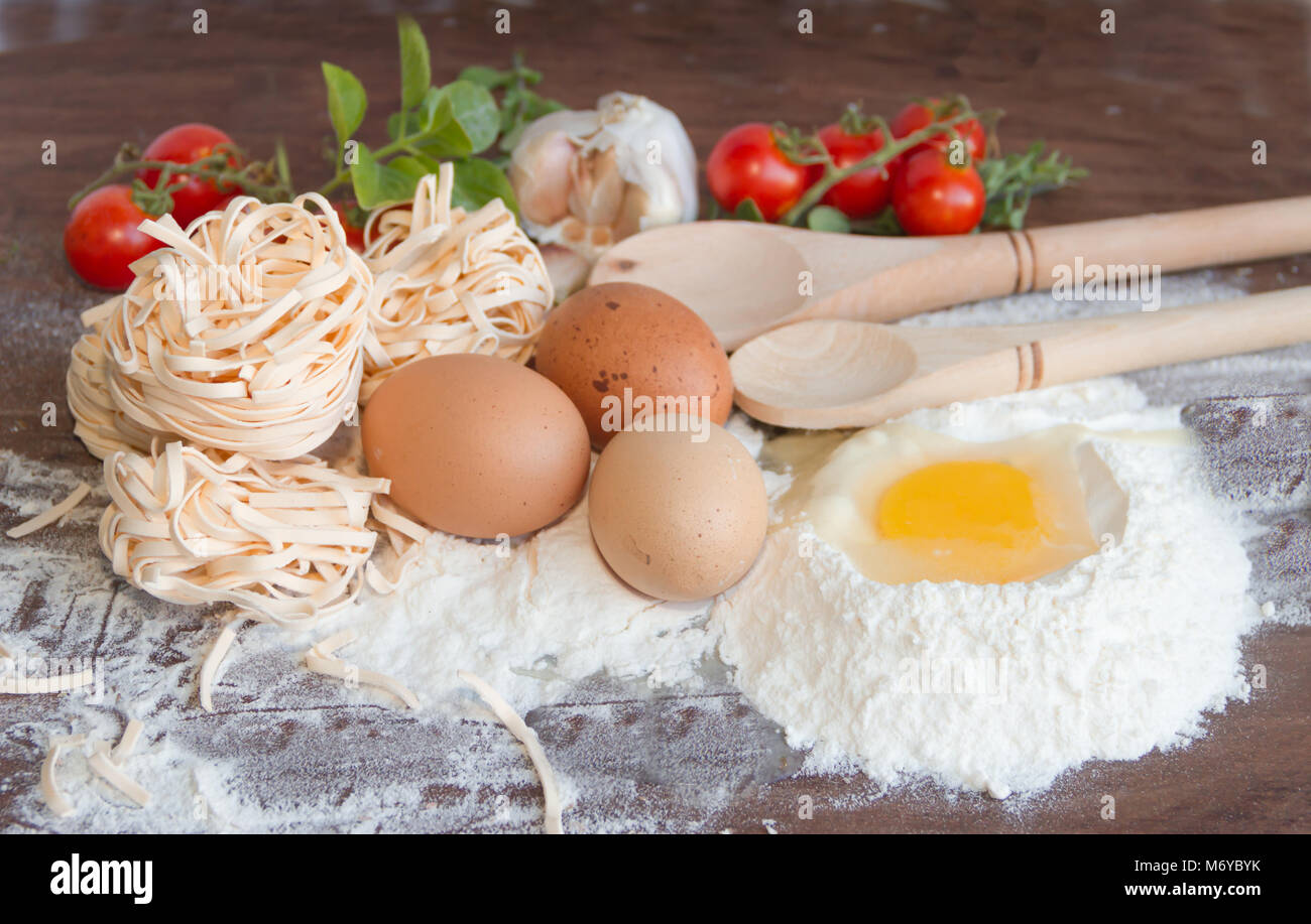 ingredients preparation spaghetti with eggs, tomatoes herbs and spices ...
