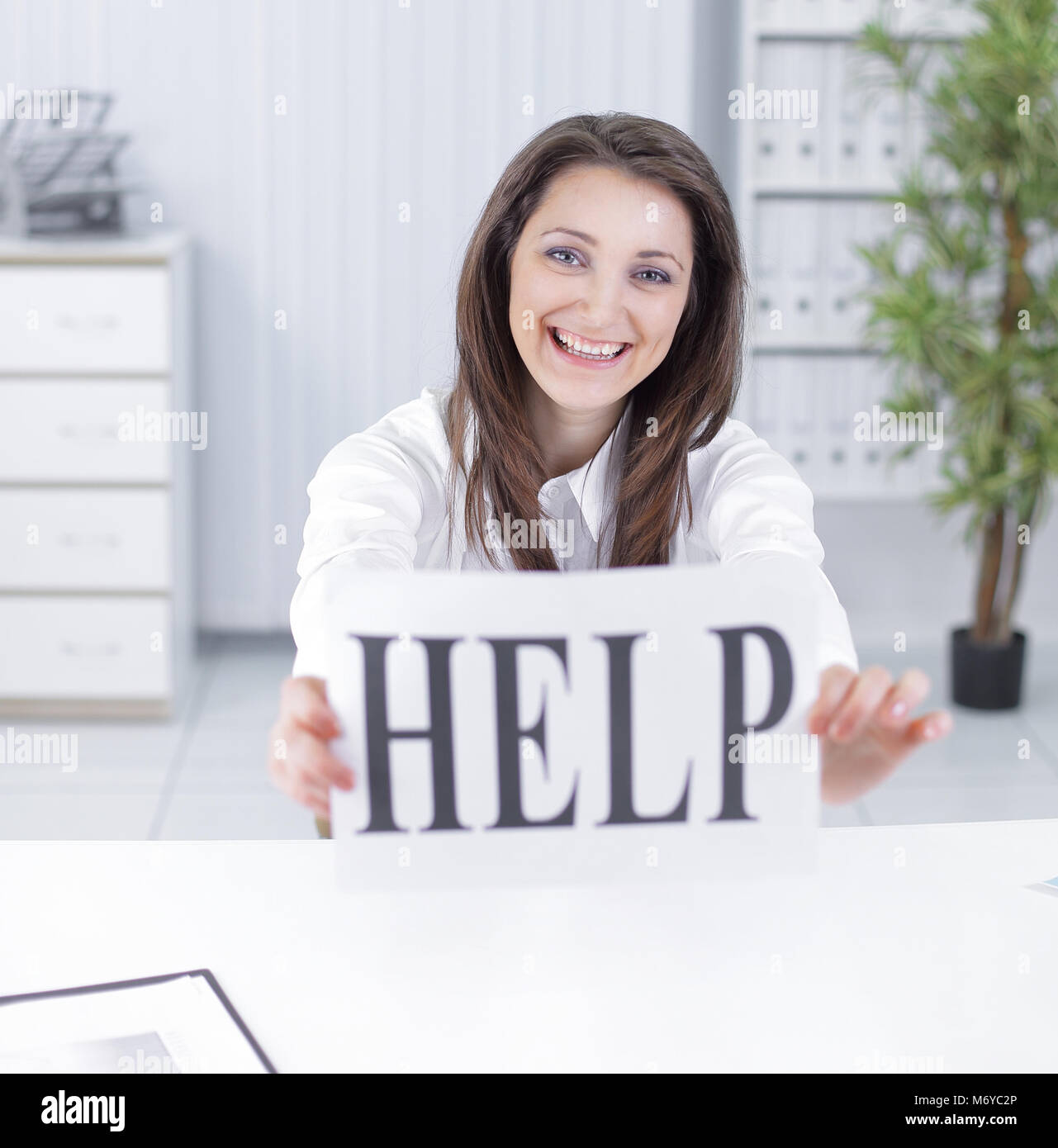 smiling business woman showing a sheet with the word help Stock Photo ...