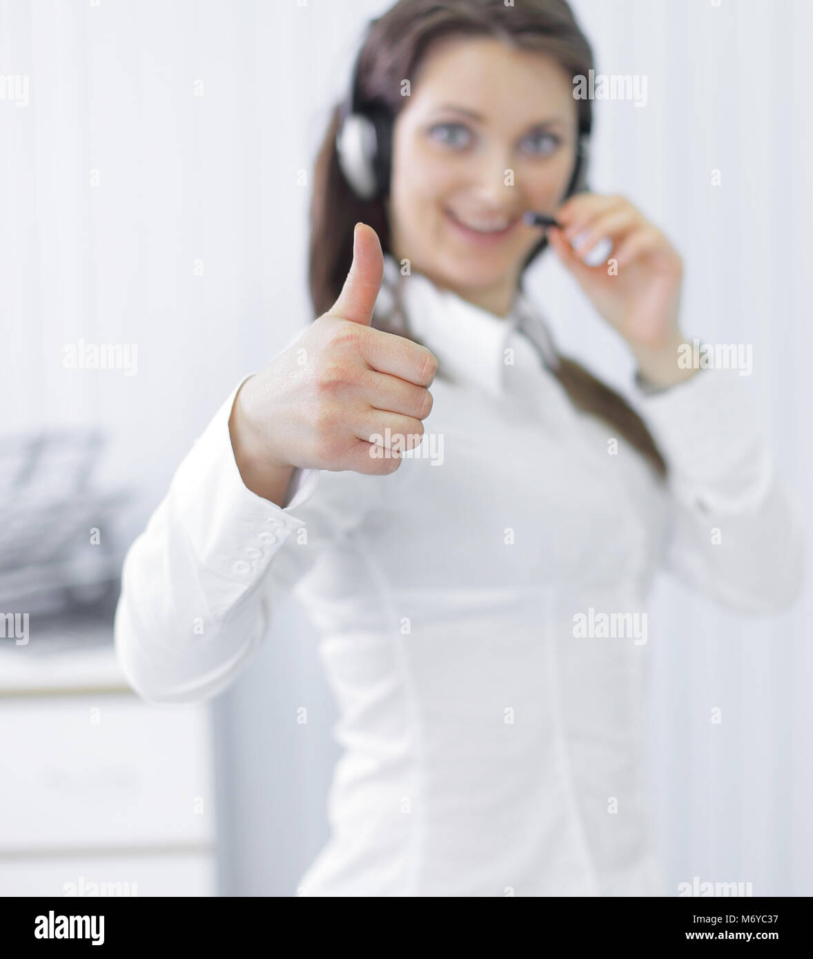 young employee call center showing thumb up Stock Photo - Alamy