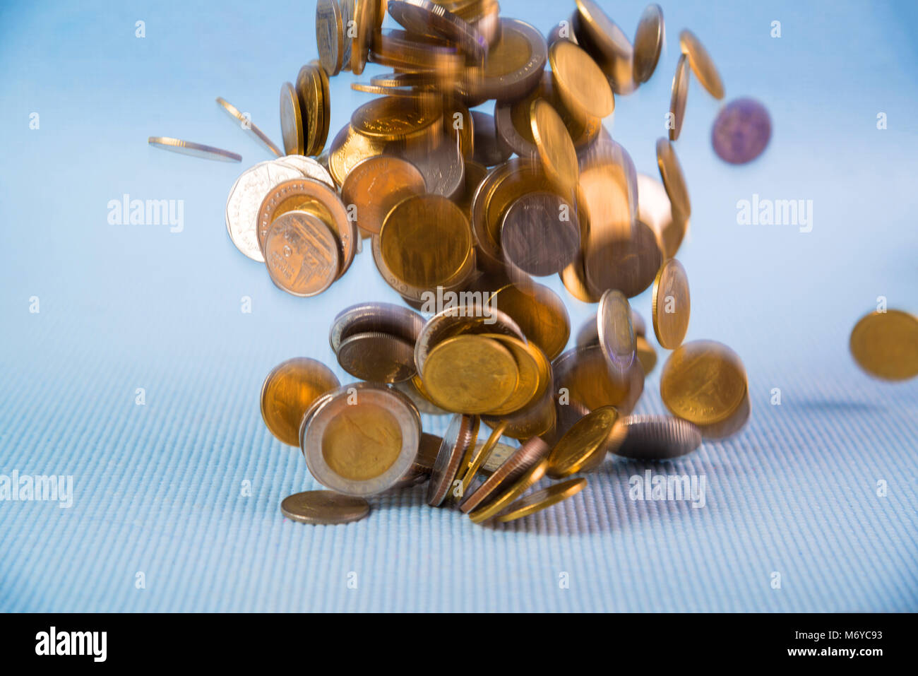 Falling coins money on blue background, business wealth concept idea ...