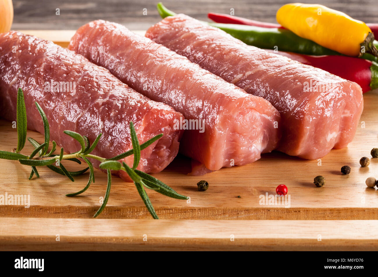 Raw pork chops on cutting board and vegetables Stock Photo - Alamy