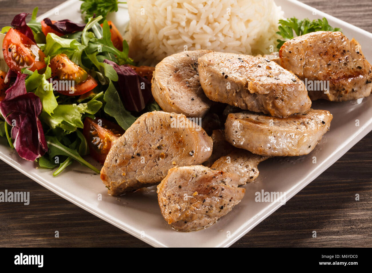 Fried pork loin,white rice and vegetable salad Stock Photo - Alamy