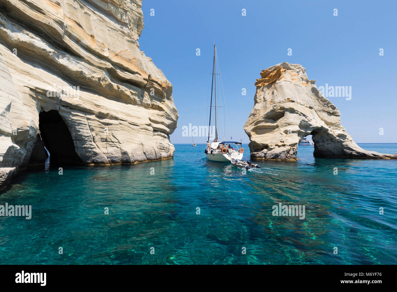 Sea caves and rock formations with crystal clear water at Kleftiko ...