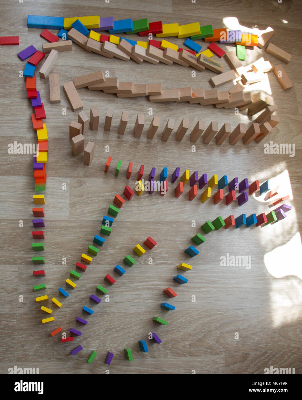 Colorful Domino Blocks in a line on a white background Stock Photo - Alamy