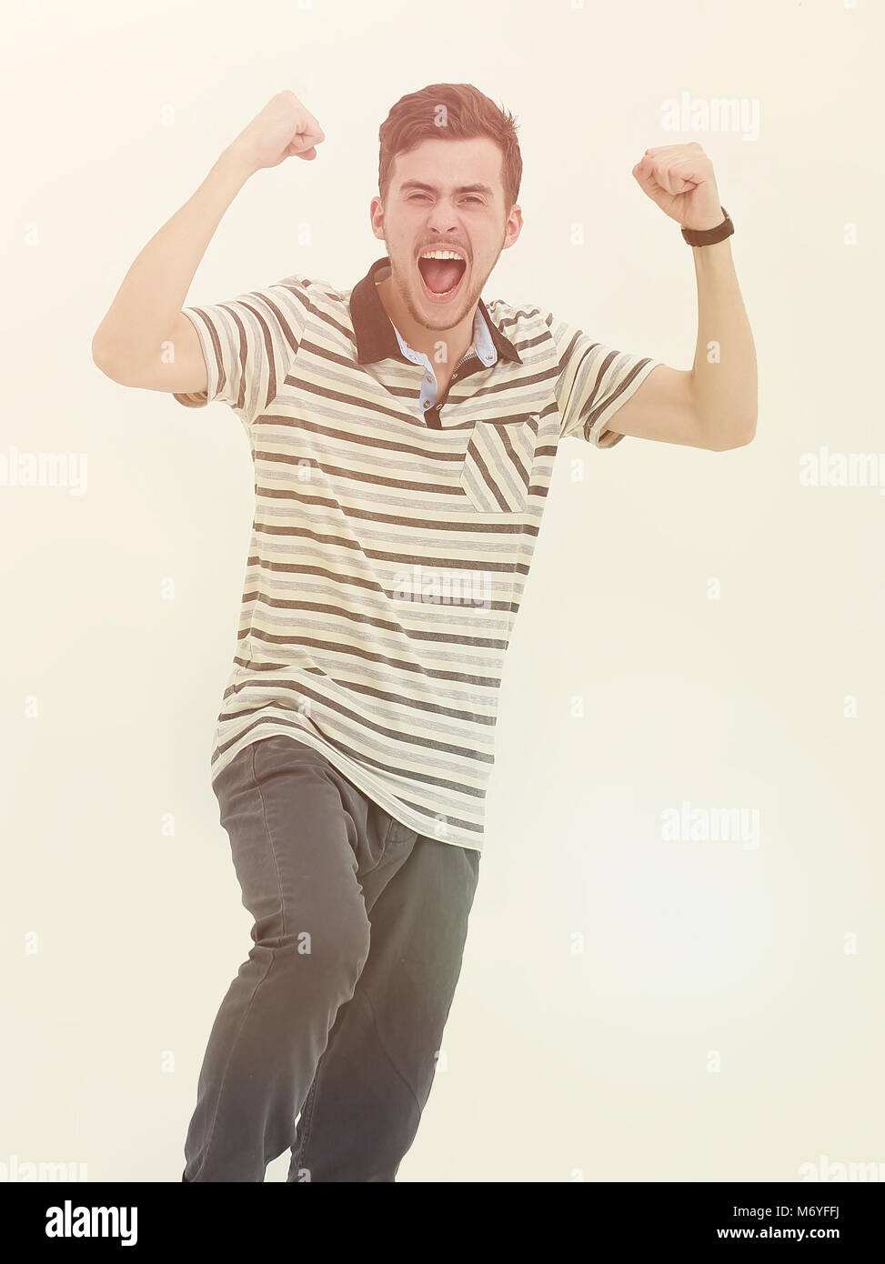 Happy young man celebrating success Stock Photo - Alamy