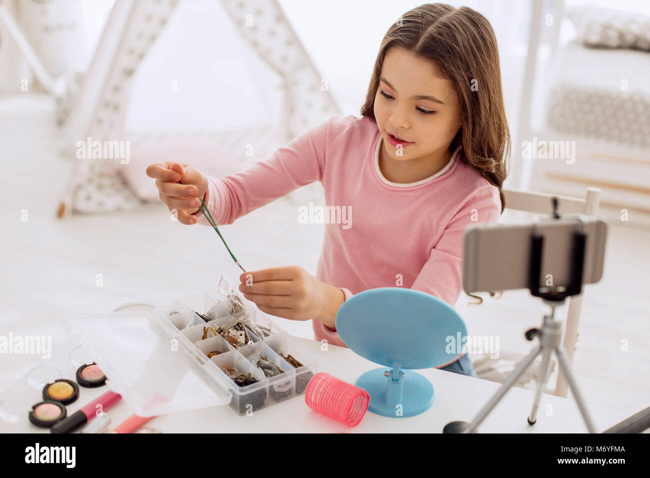 Cute girl choosing necklace while filming vlog Stock Photo - Alamy Cute girl choosing necklace while filming vlog Stock Photo - Alamy