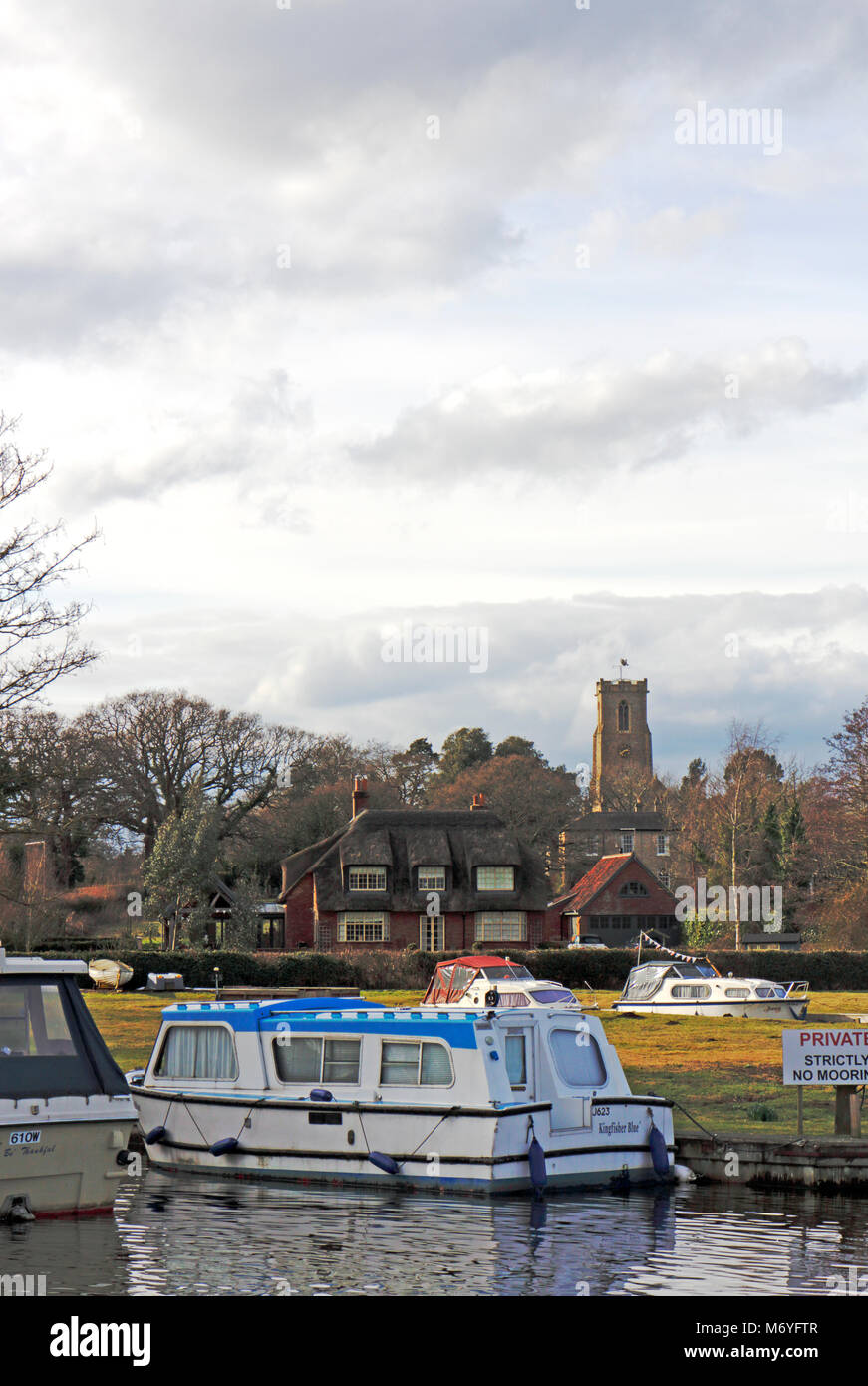 A view of boats moored at Malthouse Broad with the parish Church in the ...
