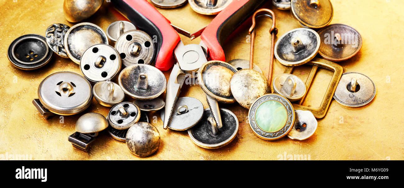 Buttons from clothes, sewing tool and pliers Stock Photo - Alamy