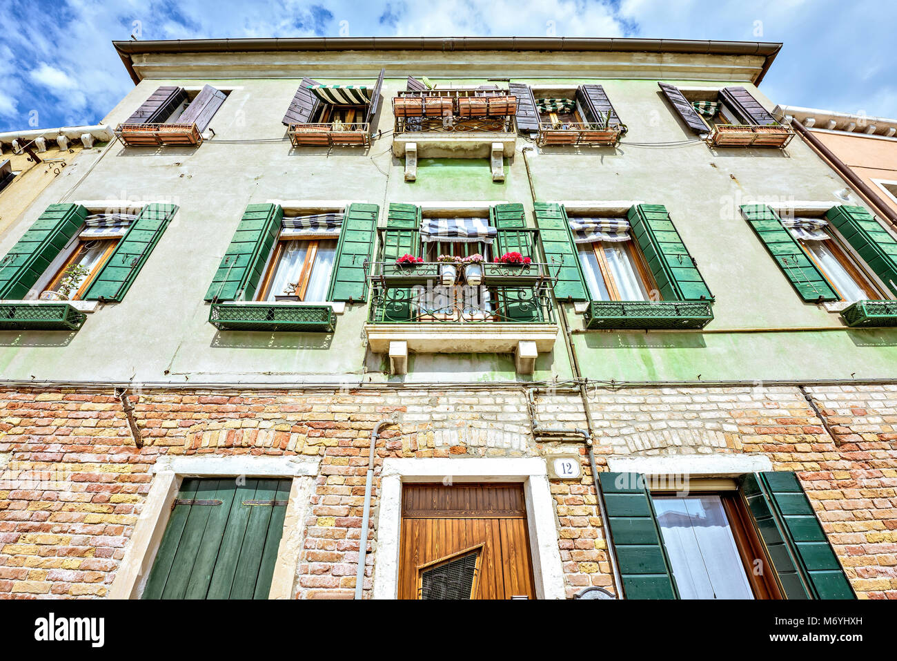 Daylight view from bottom to historic architecture building with green ...