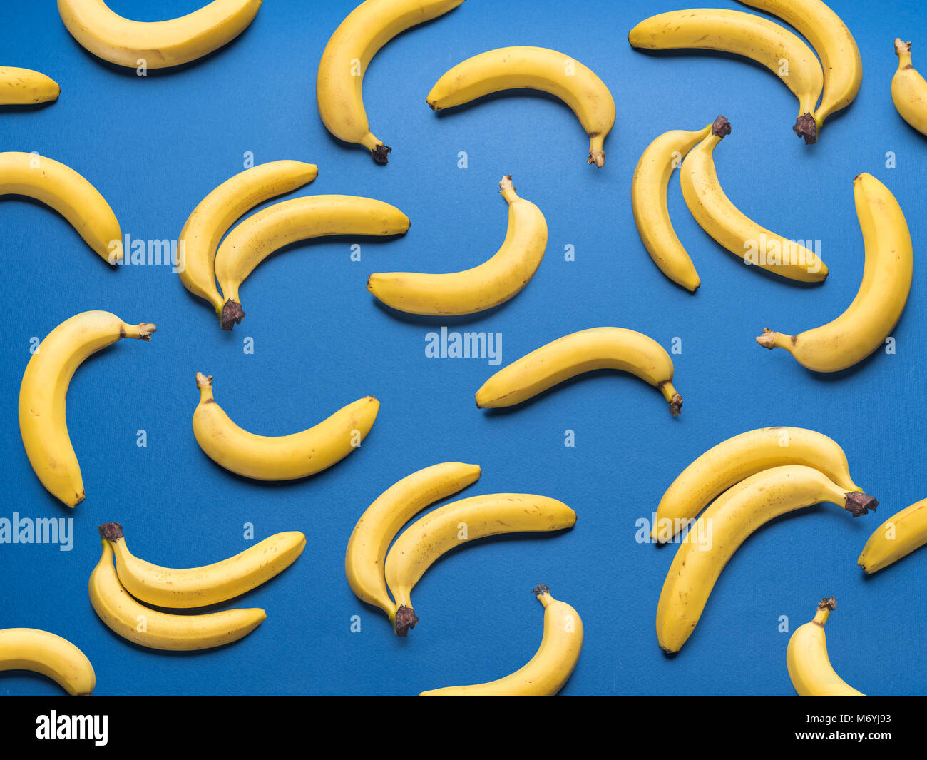 Bananas on the blue background Stock Photo - Alamy