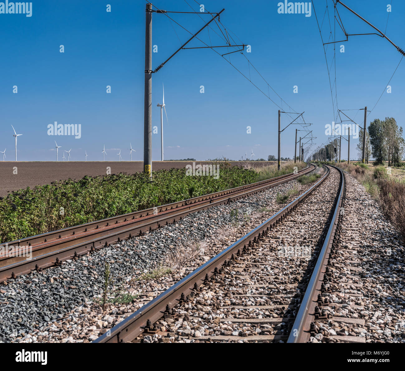 By rail train along wind power plant Stock Photo - Alamy