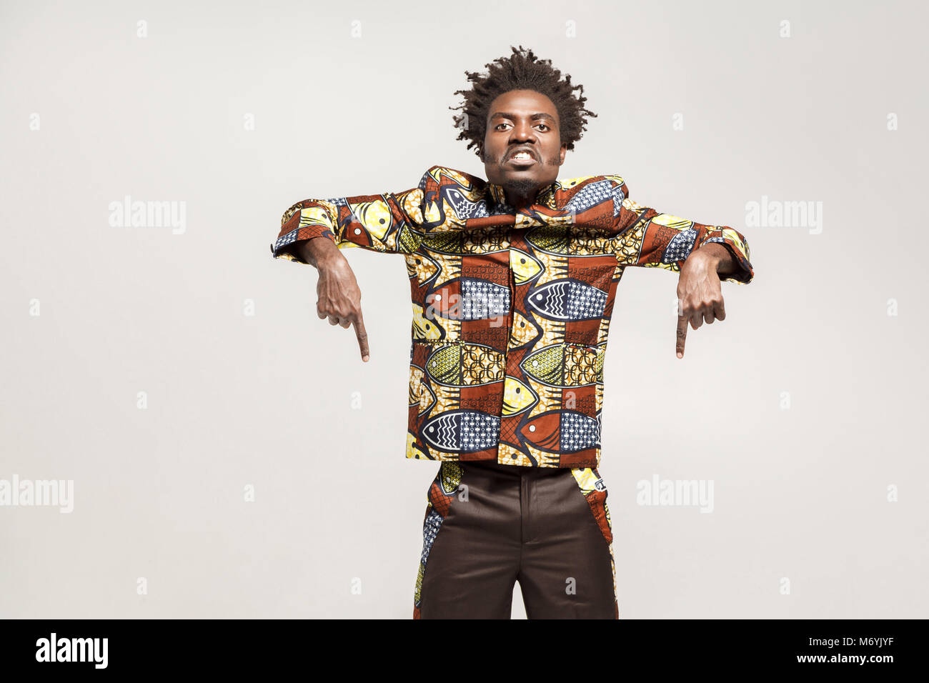 Hey! Look down, now! Angry african dictator pointing fingers . Indoor ...