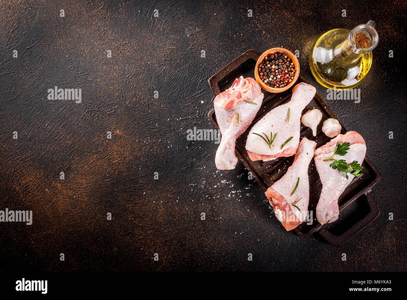 Raw meat, ready for grill or barbeque chicken legs, with herbs and ...