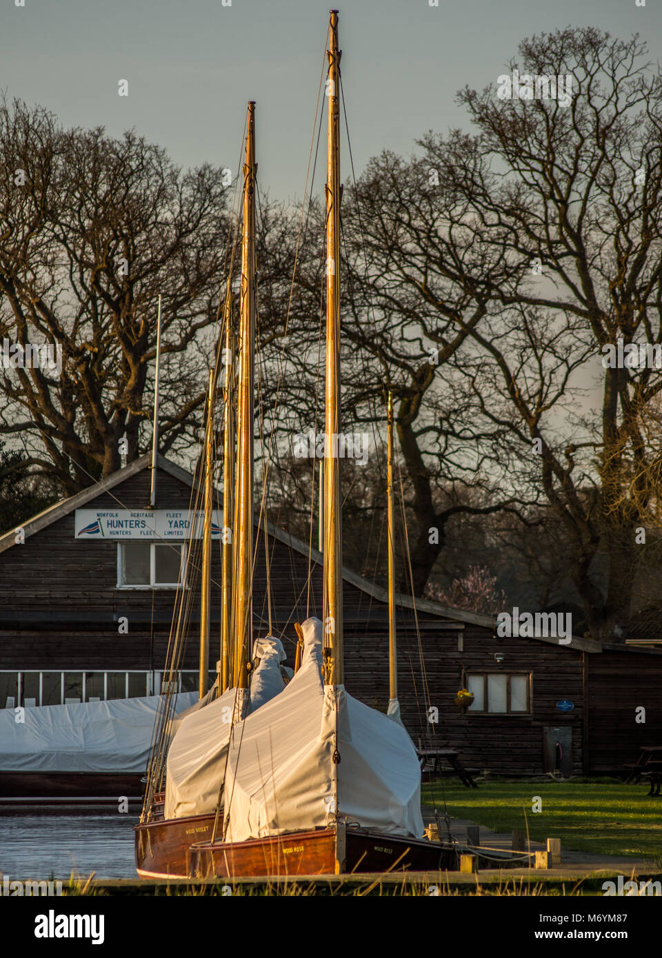 Sailing boat with mast moored at dusk Stock Photo - Alamy