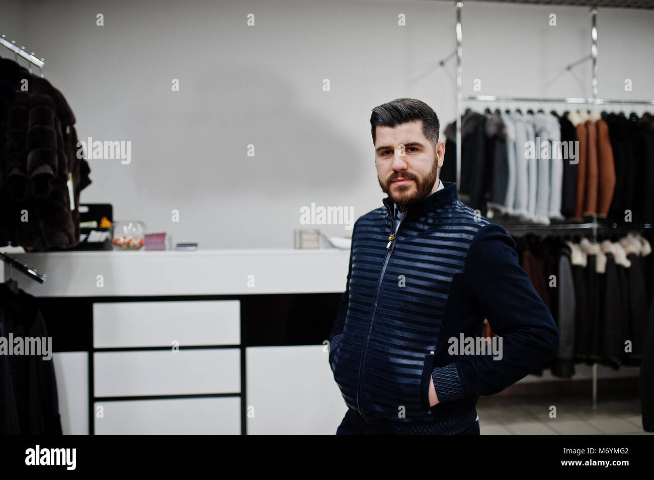 Stylish turkish man at the store of fur coats and leather jackets ...