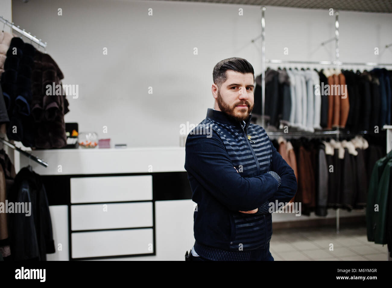 Stylish turkish man at the store of fur coats and leather jackets ...