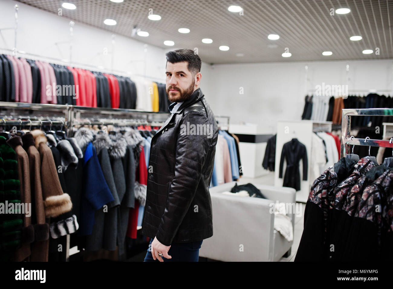Stylish turkish man at the store of fur coats and leather jackets ...