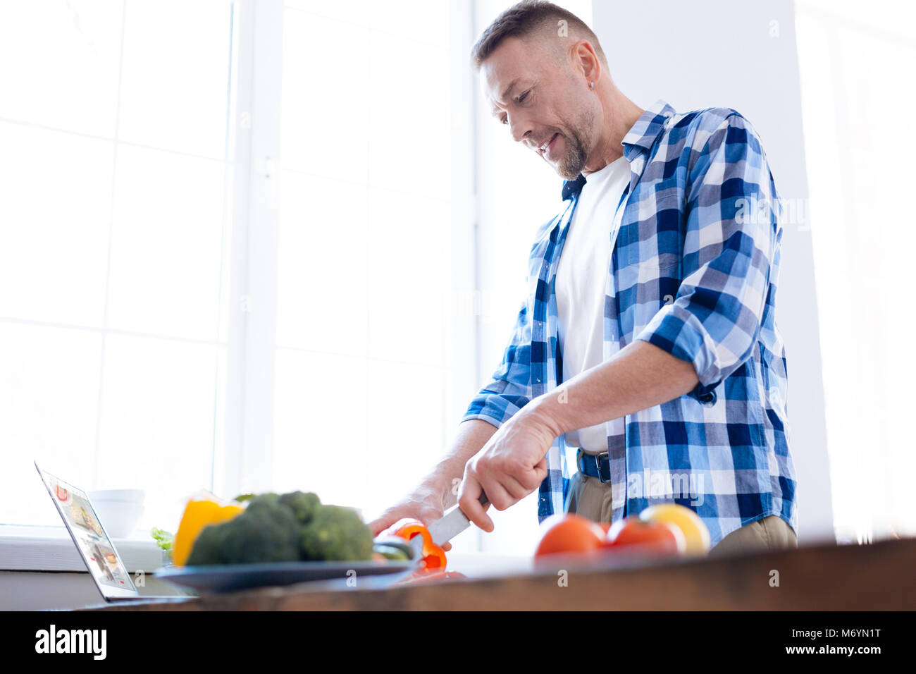 Concentrated handsome man studying biohacking Stock Photo - Alamy